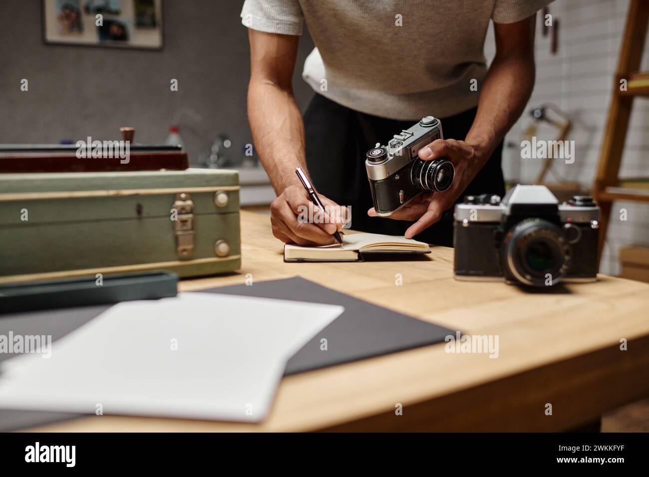 cropped african american photographer immersed in writing holding his ...
