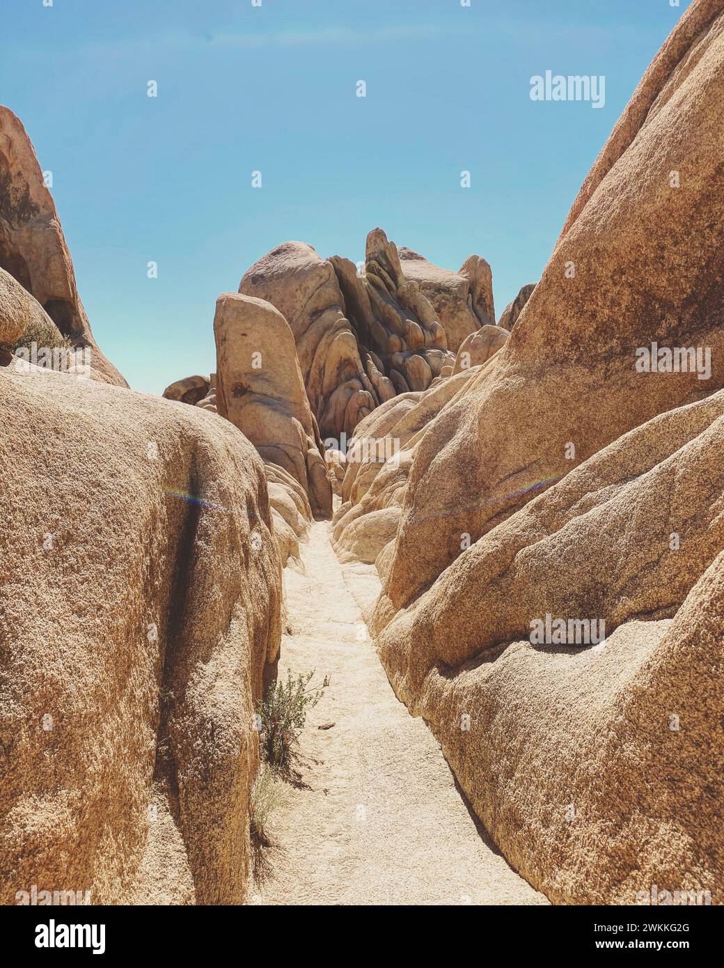 Smooth rounded rock walls surround a dirt trail Stock Photo - Alamy