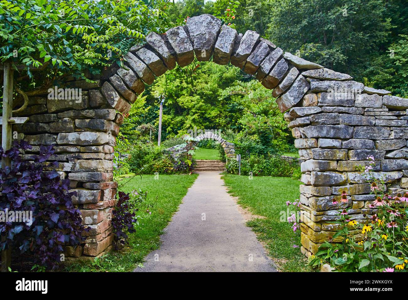 Rustic Stone Arches in Serene Garden Pathway Stock Photo - Alamy