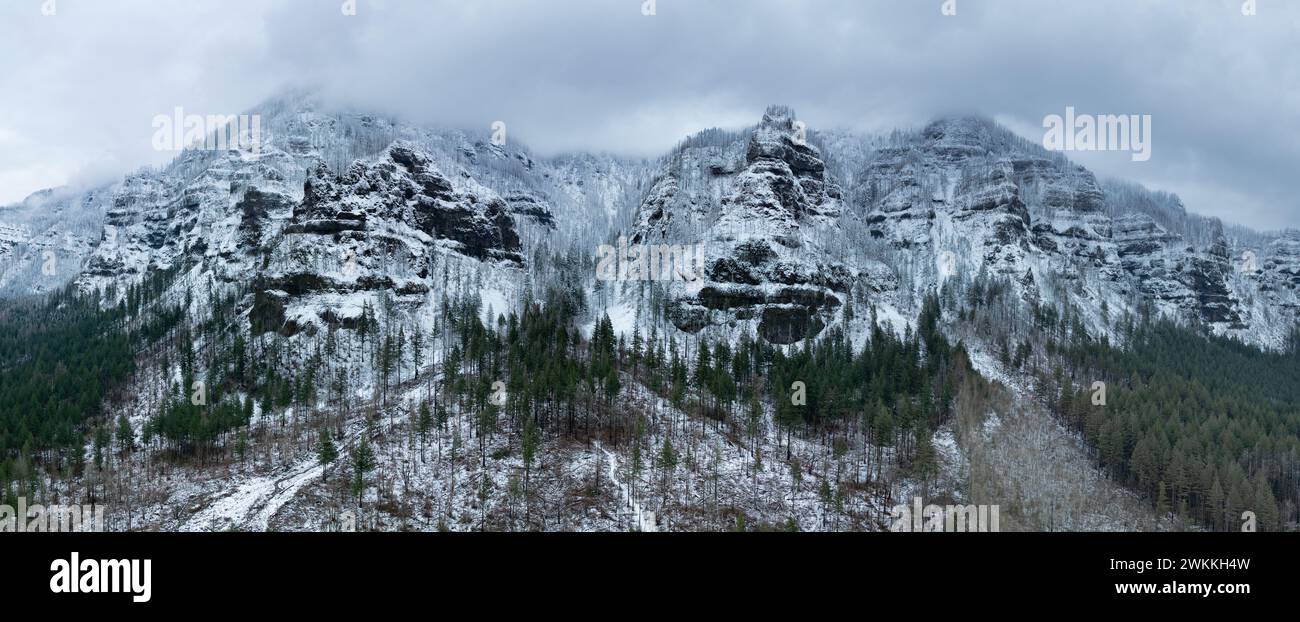 Clouds and snow covers the rugged mountain landscape in the Columbia ...