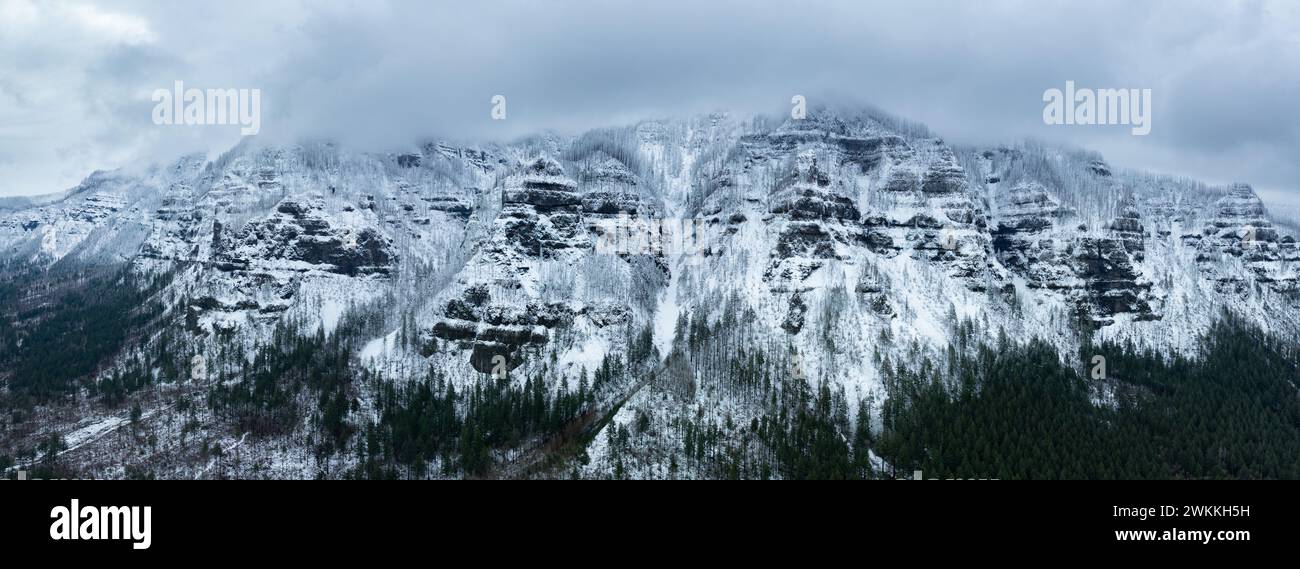 Clouds and snow covers the rugged mountain landscape in the Columbia ...
