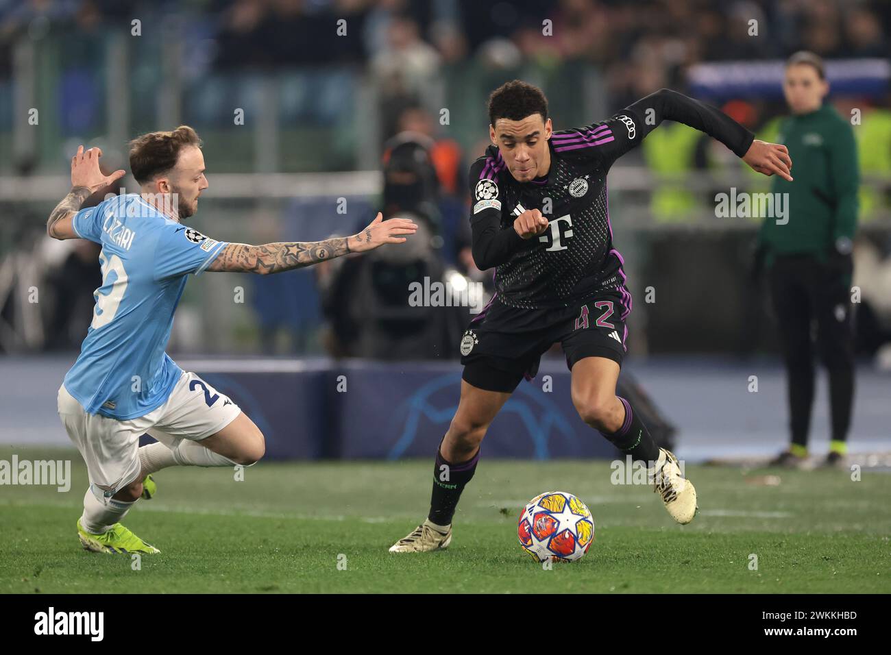 Rome, Italy, 14th February 2024. Jamal Musiala of Bayern Munchen takes on Manuel Lazzari of SS ...