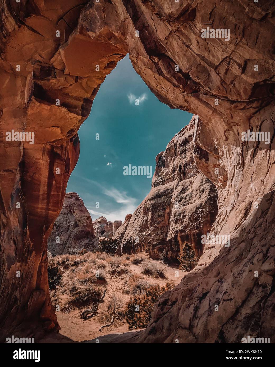 Rock Archway frames scenic cliffs Stock Photo - Alamy