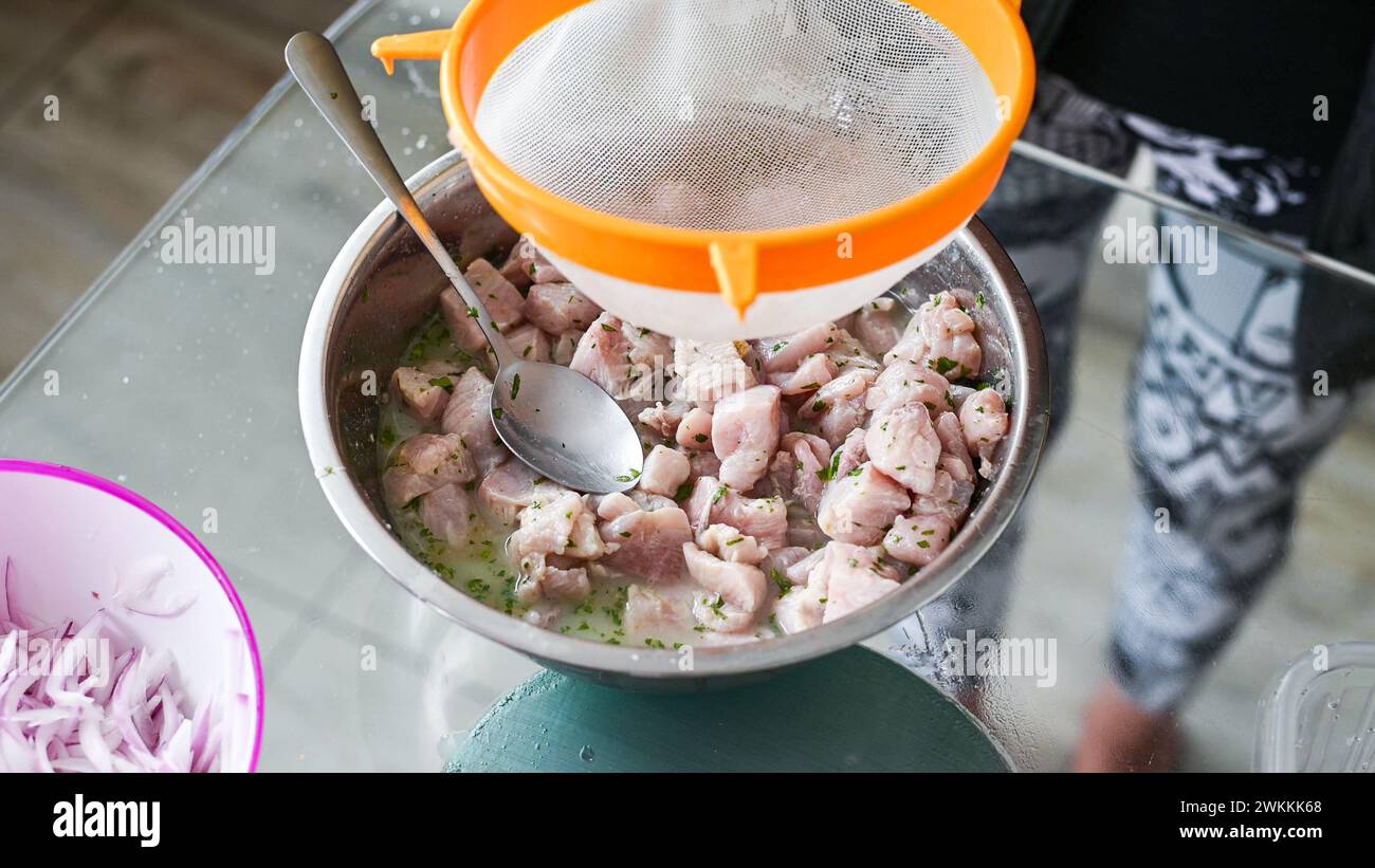 Peruvian food ceviche. 5 Preparation of the ceviche, straining the ...