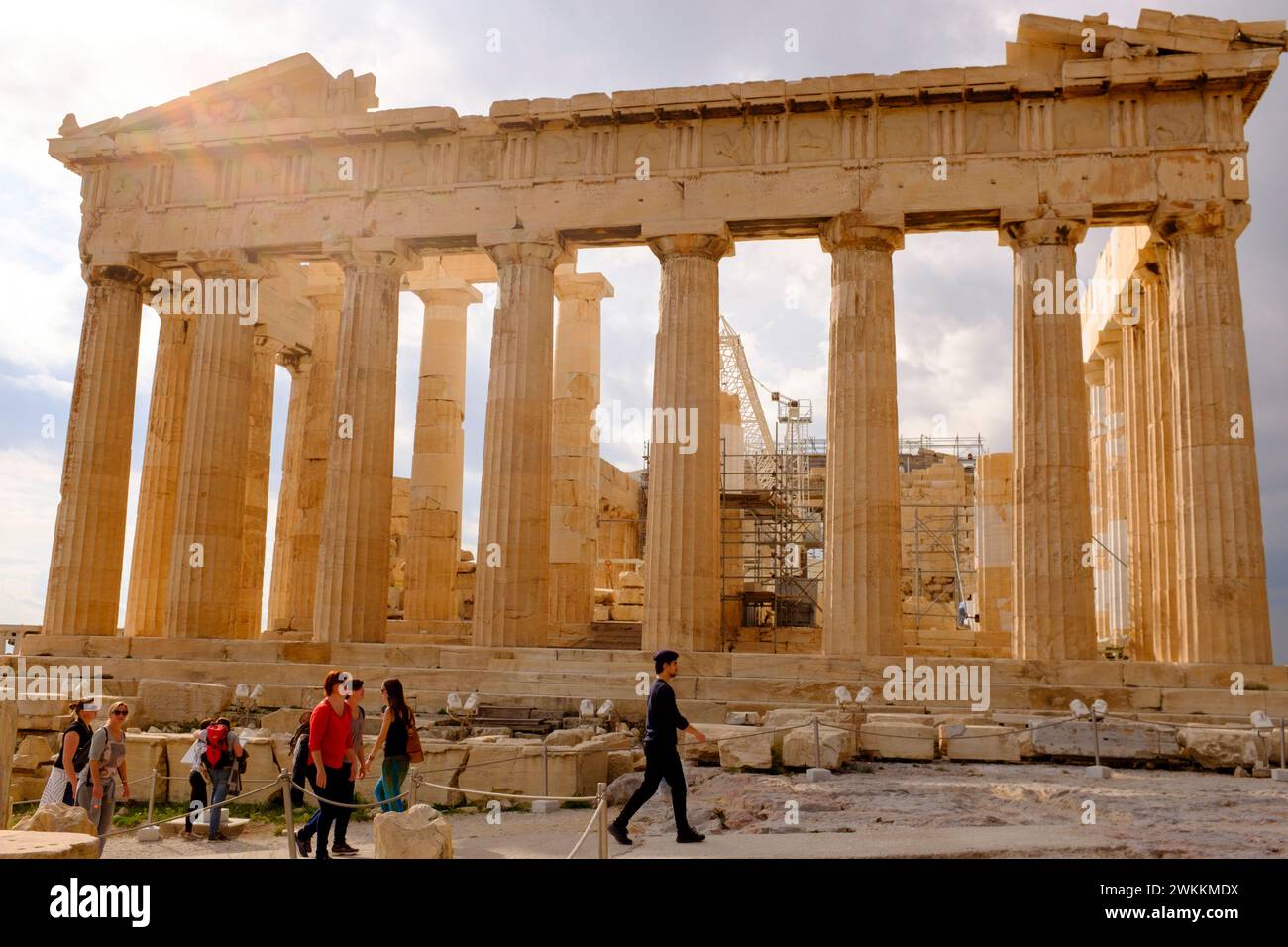 Tourists visit the Parthenon while a storm moves in at the Acropolis in ...