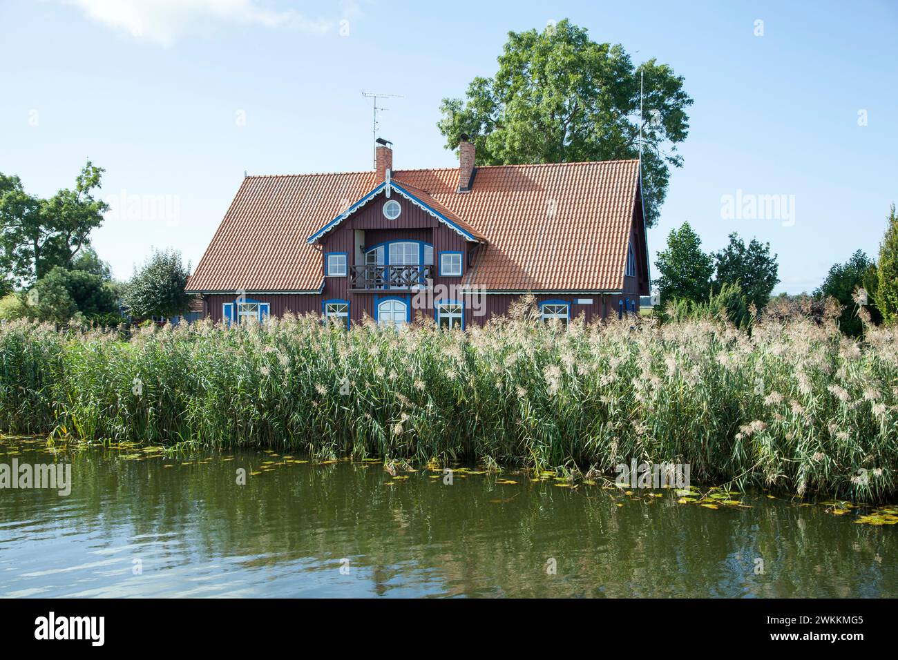 The early Autumn view of a house by Minija River in Minge village, the ...