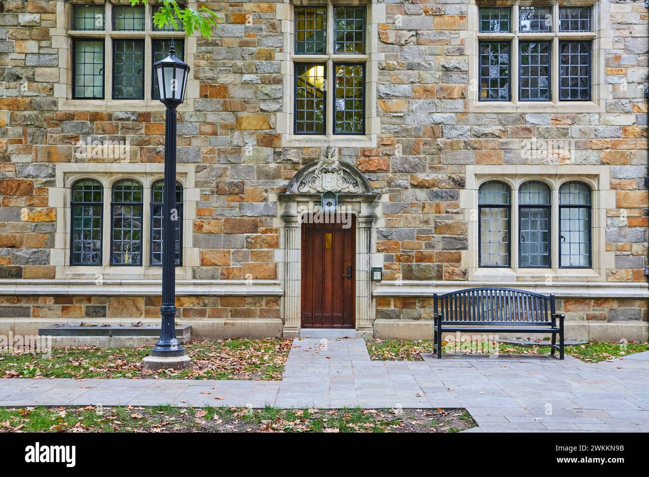 Traditional University Building with Lamppost and Bench Stock Photo - Alamy