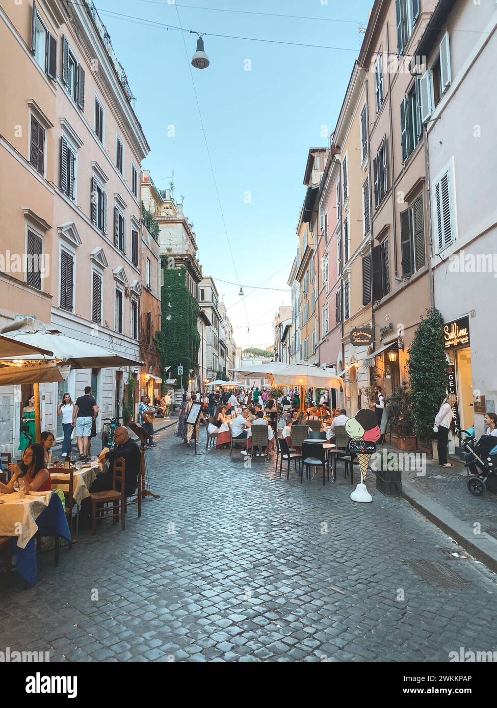 Outdoor diners on a Roman cobblestone street Stock Photo - Alamy