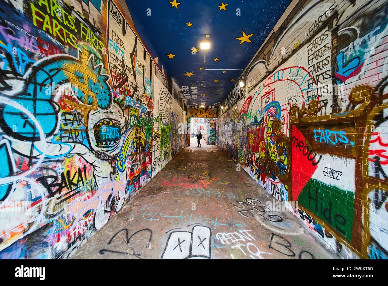 Colorful Urban Graffiti Art in Alleyway with Silhouetted Figure Stock ...