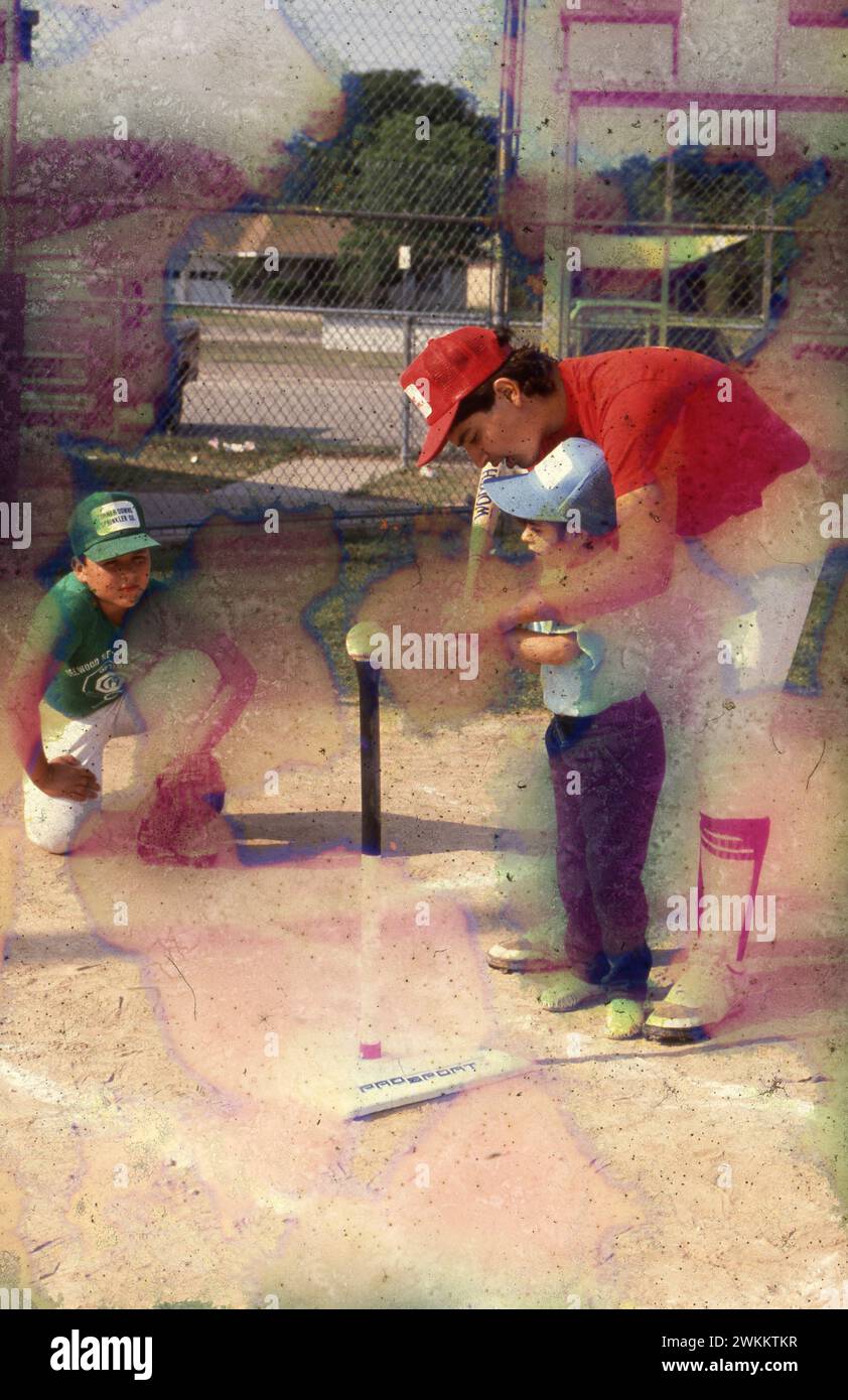 14-year-old brother shows four-year-old little brother how to bat a ...