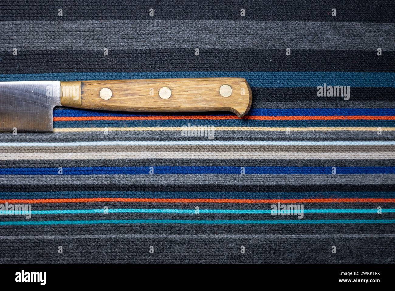 Wool fabric knitted with horizontal lines and knife handle visible ...