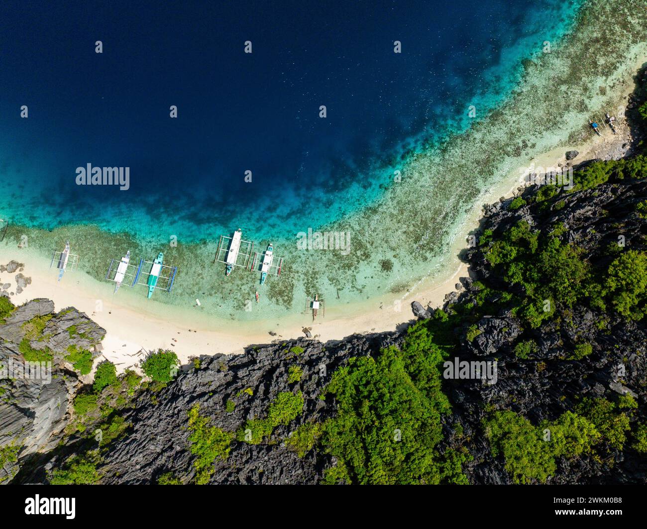 Top view of Talisay Beach and boats floating over clear sea warer ...
