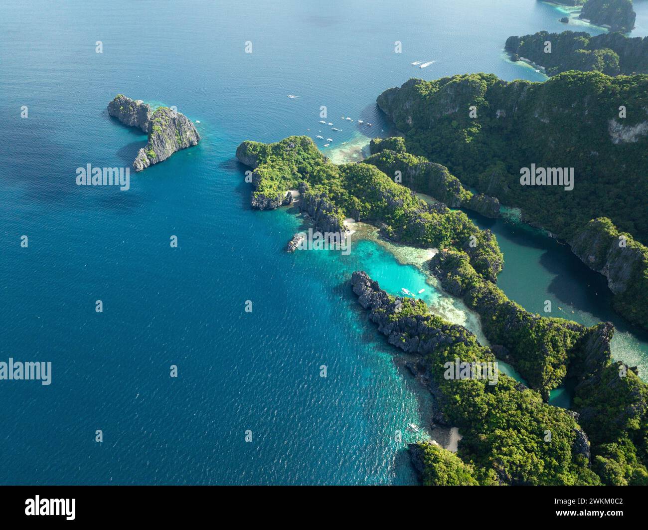 Twin Rocks and Lagoons with boats and kayaks. Miniloc Island. El Nido ...