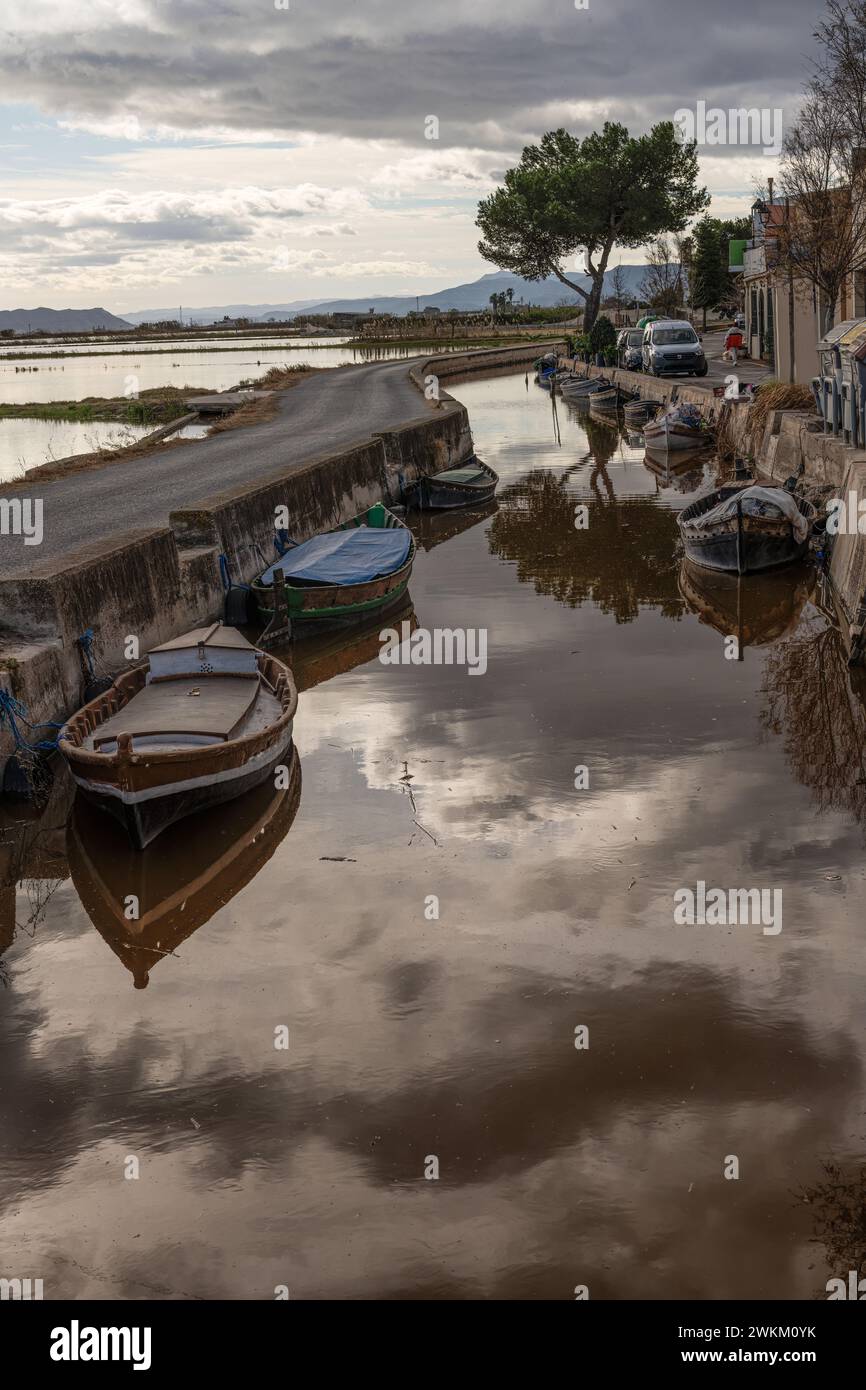 Traditional wooden boats moored along a canal, with the rustic charm of ...