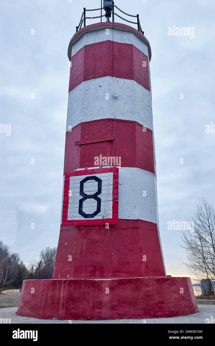 Small Lighthouse painted in red and white stripes with number eight 8 ...