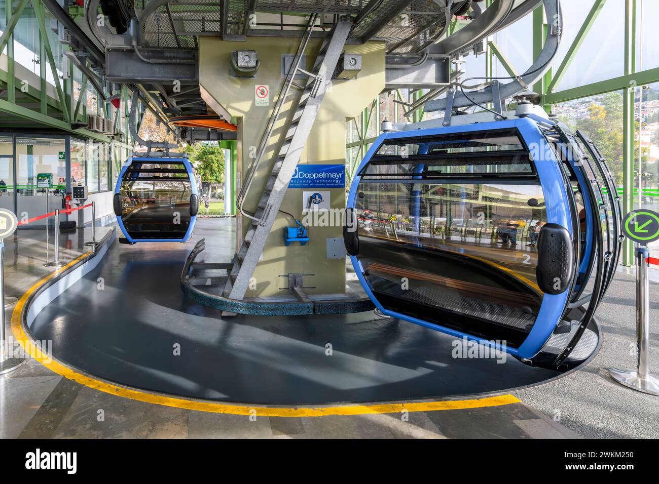 Moving cable car gondolas on a track arrive inside the Teleferico Cable ...