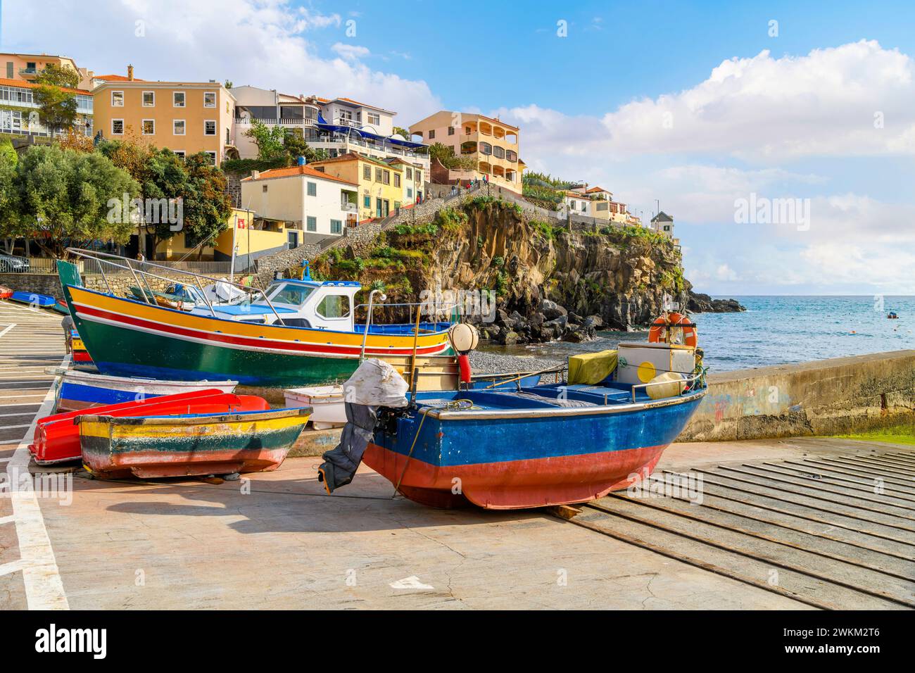 Colorful small fishing boats of blue, yellow and red line the small ...
