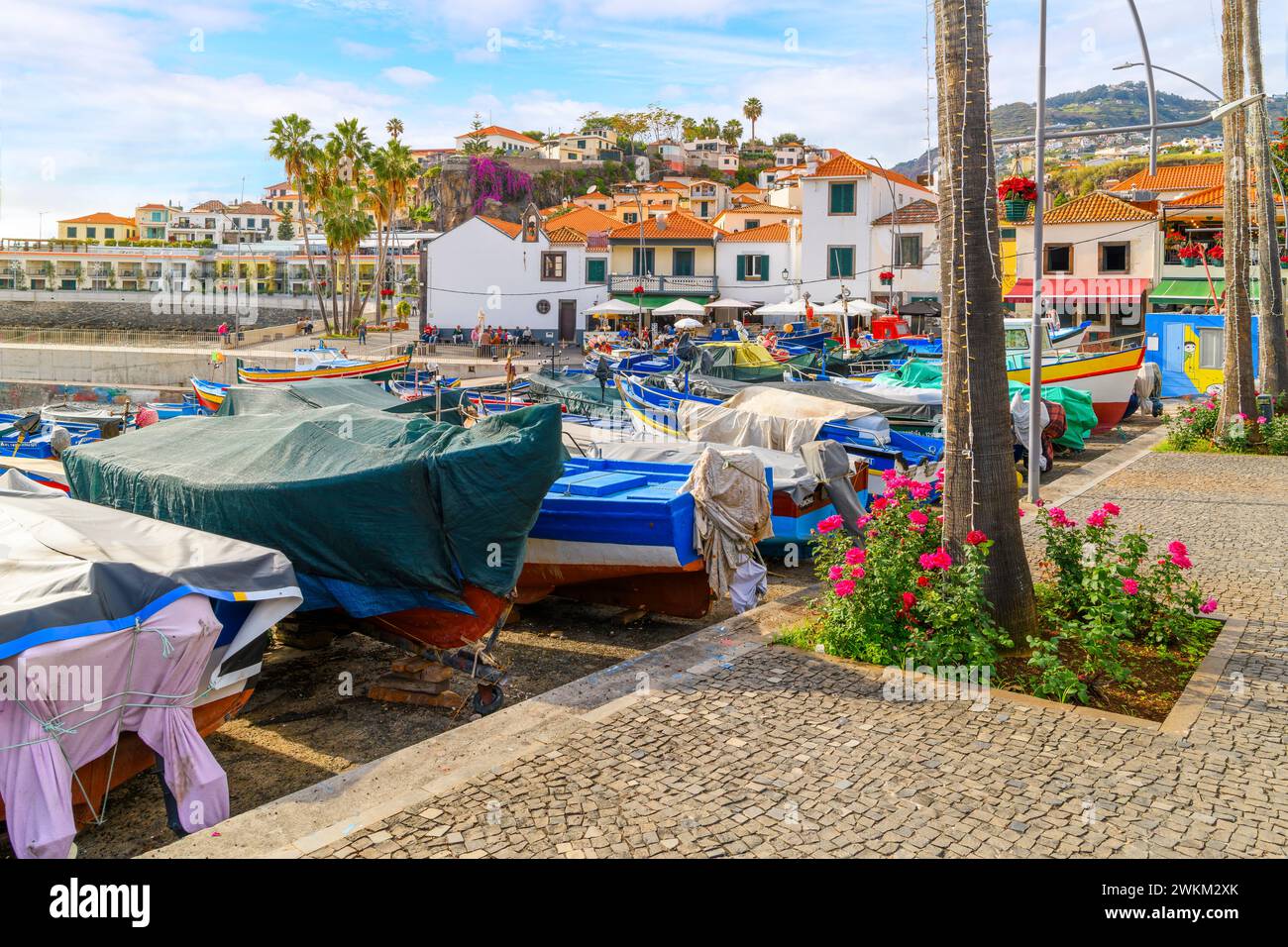 Colorful small fishing boats of blue, yellow and red line the small ...