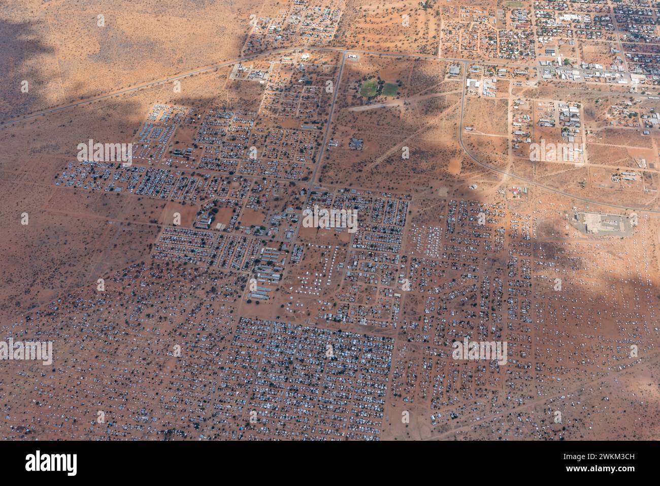 aerial cityscape with township in desert, shot from a glider plane in ...