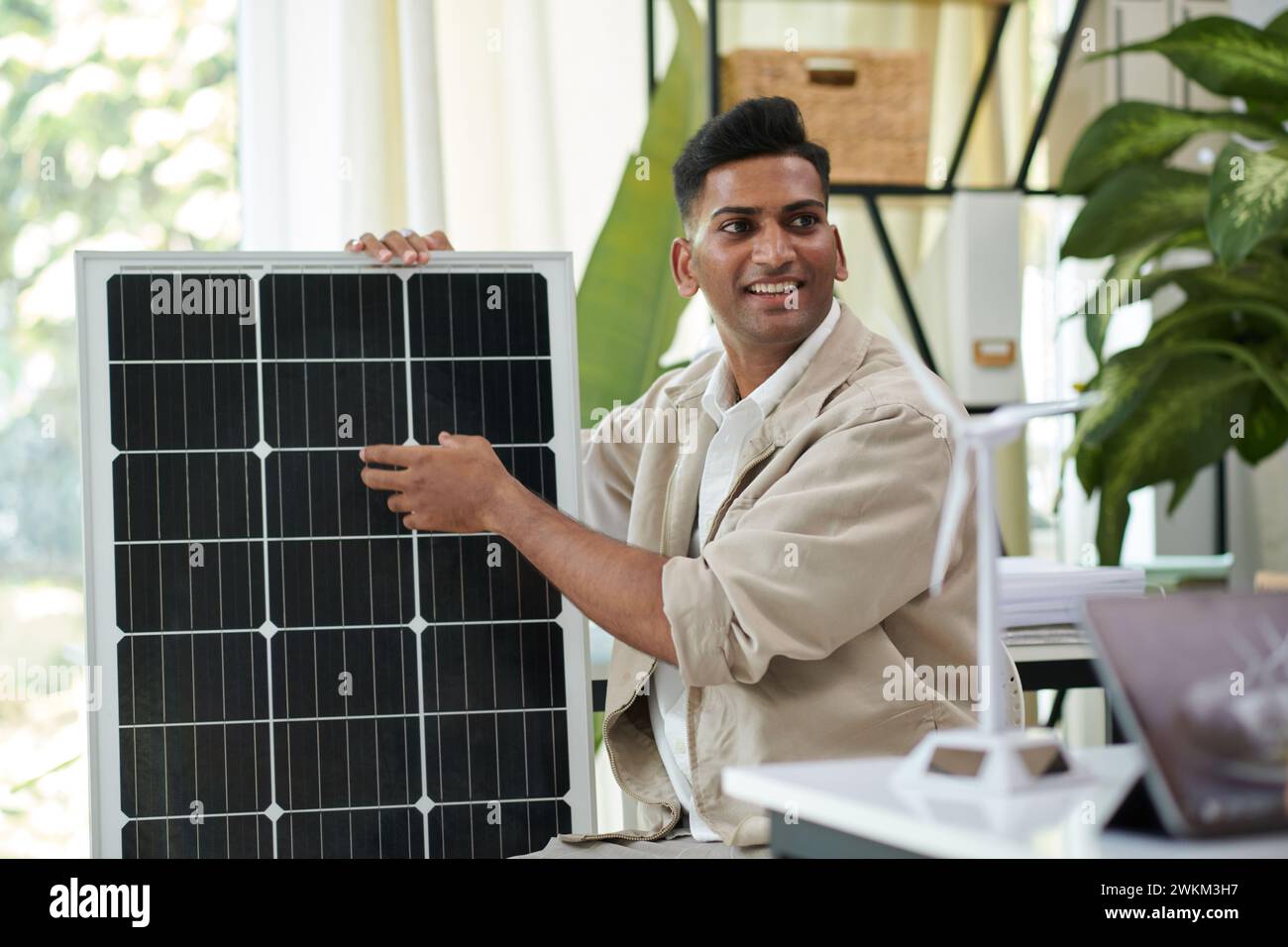 Smiling Indian man explaining how solar panel works Stock Photo - Alamy