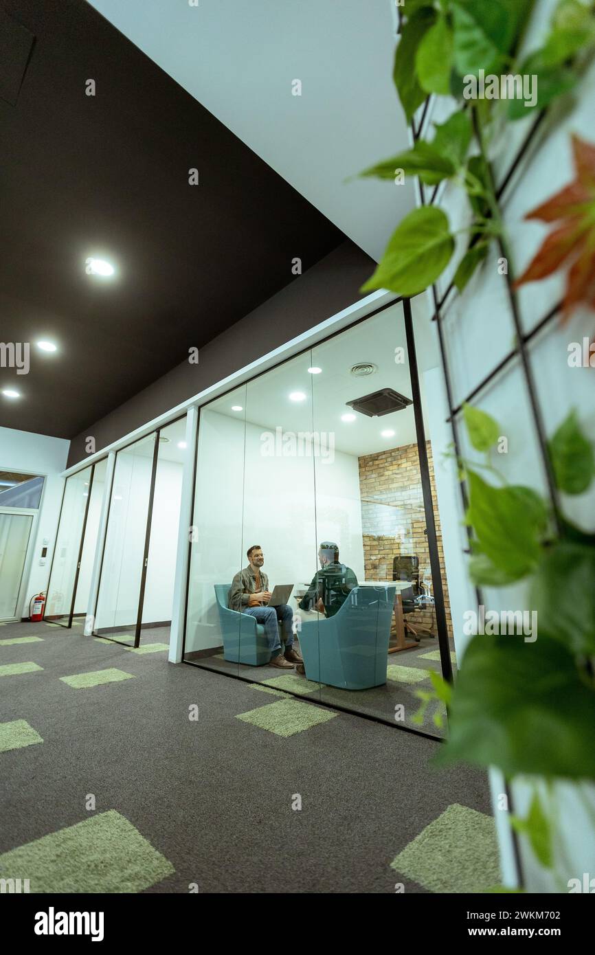 Two professionals engage in a conversation while seated comfortably in ...