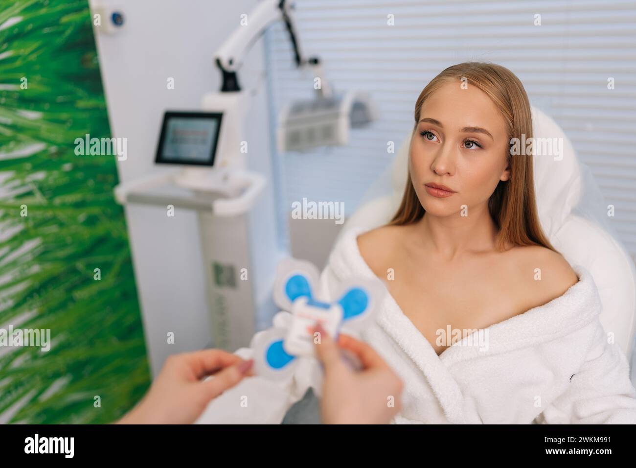 View from shoulder of unrecognizable female cardiologist puts holter ...