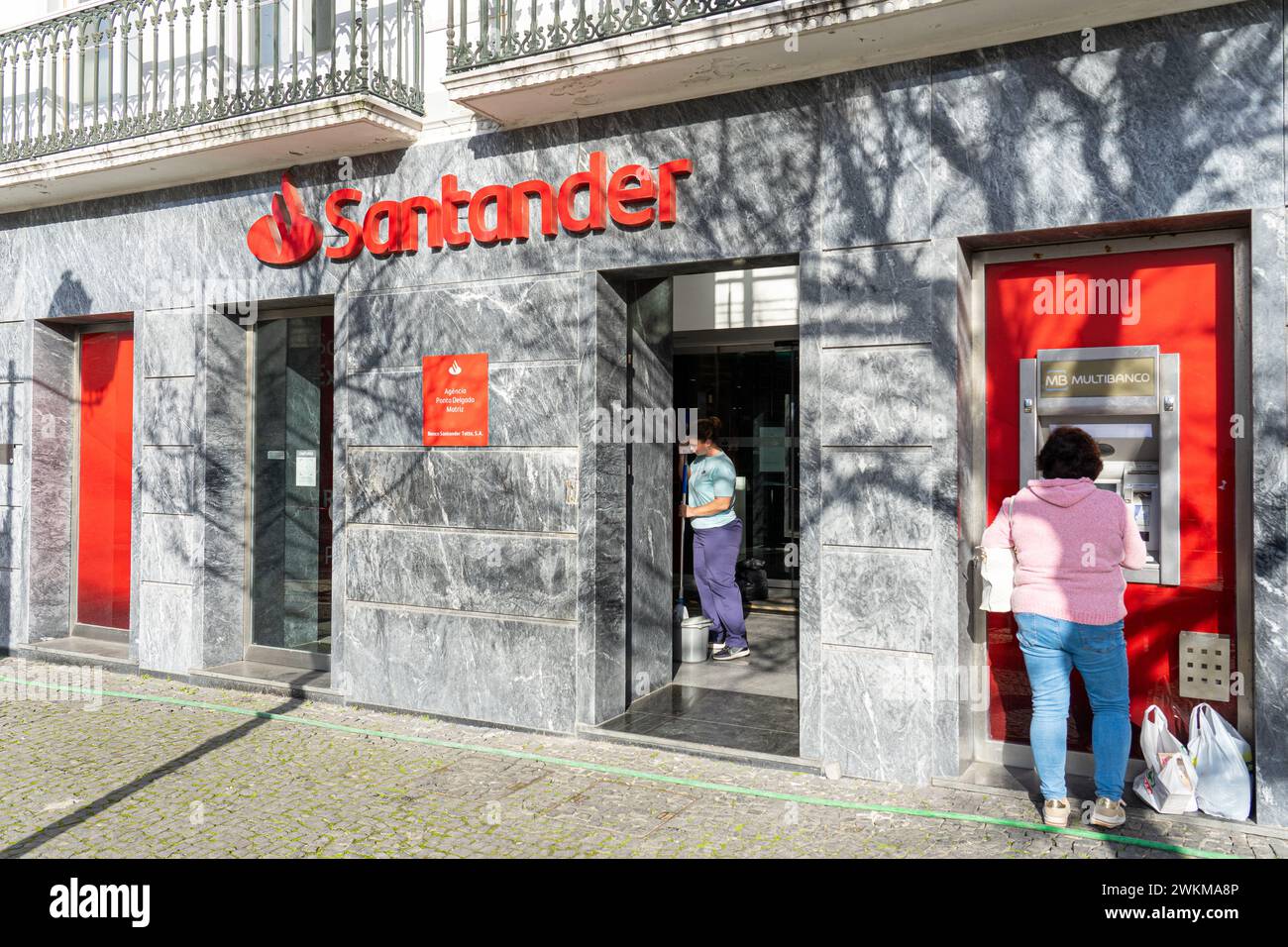 Santander bank branch facade with woman using the ATM.Ponta Delgada-sao ...