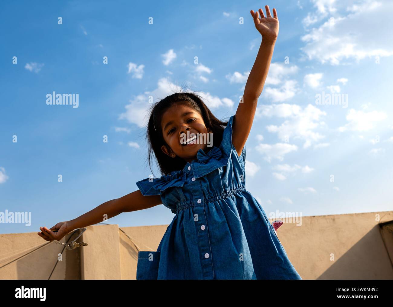 A radiant young girl throws her arms wide open Stock Photo - Alamy
