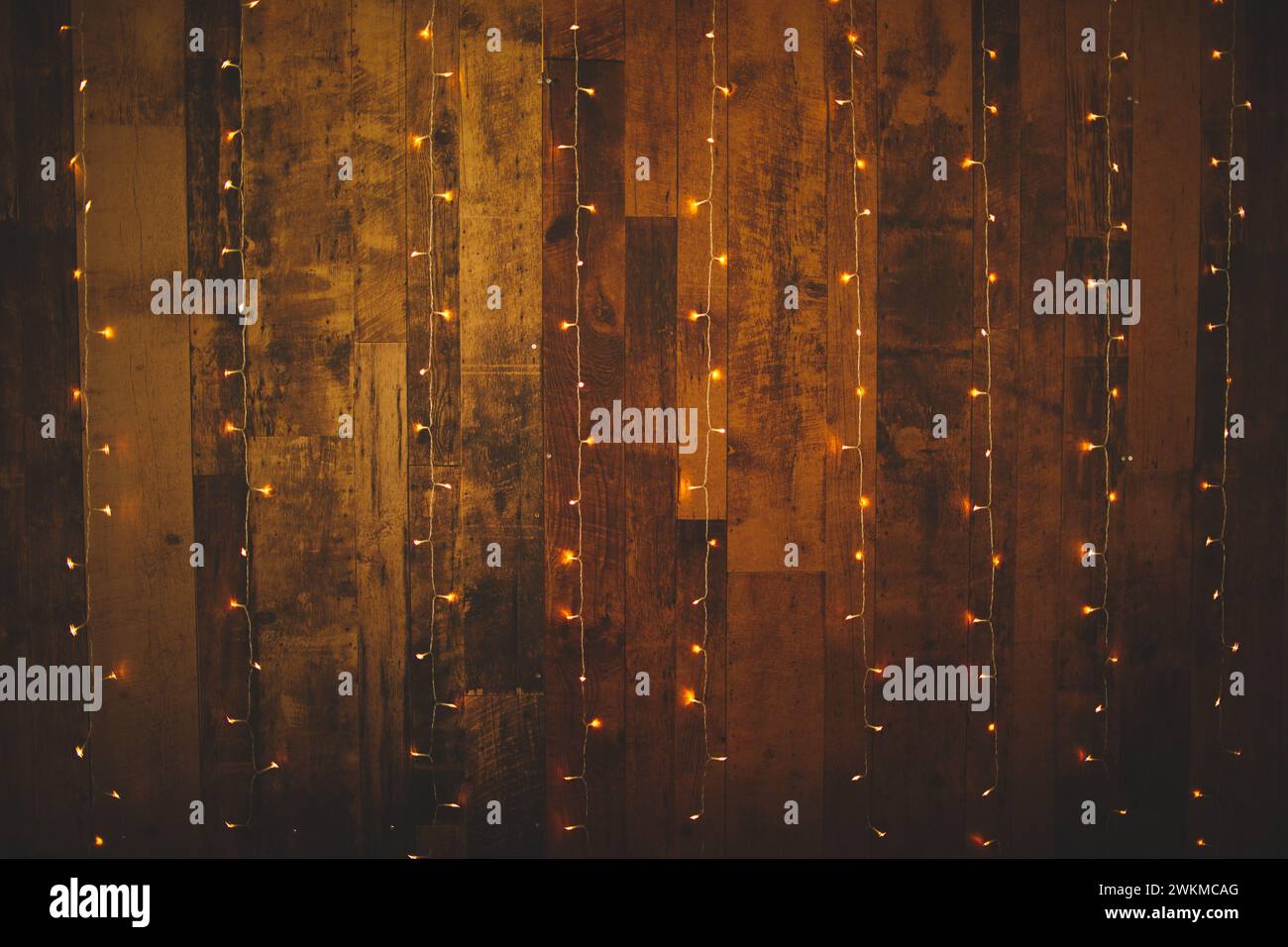 Hanging lights on dark wall background Stock Photo - Alamy