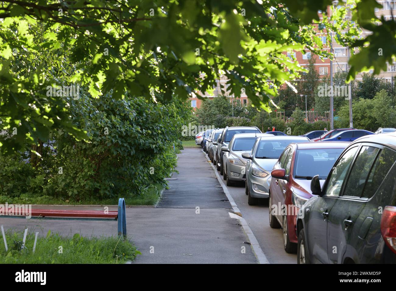 Moscow, Russia - 11 June 2023. Row of cars parked along sidewalk near ...
