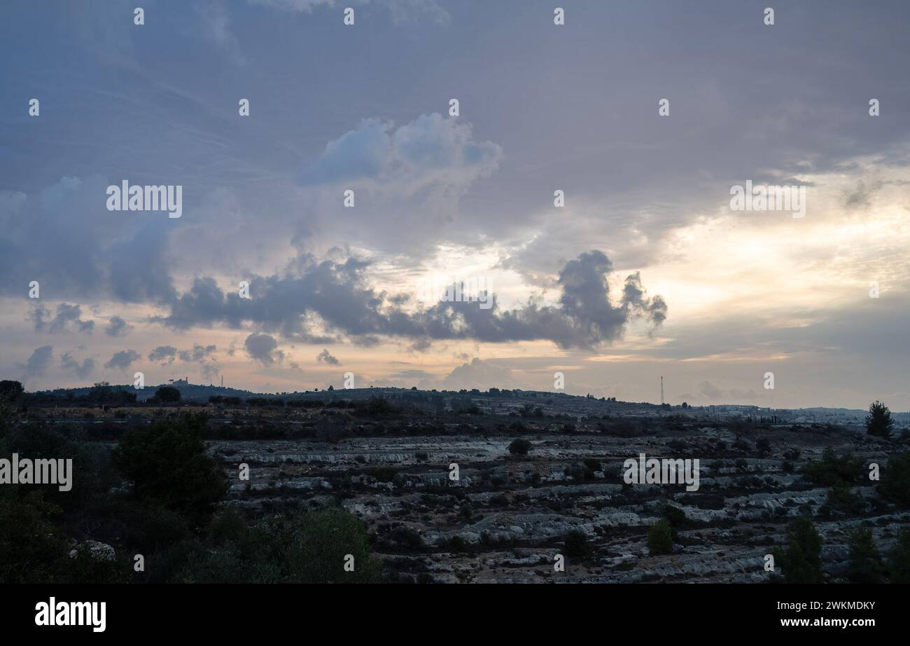 A sunrise in a cloudy sky over the Judea mountains near Jerusalem ...