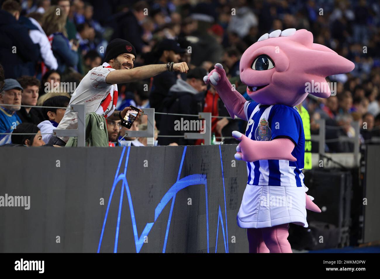 A fan bumps fists with Viena, FC Porto's female dragon mascot, before a ...