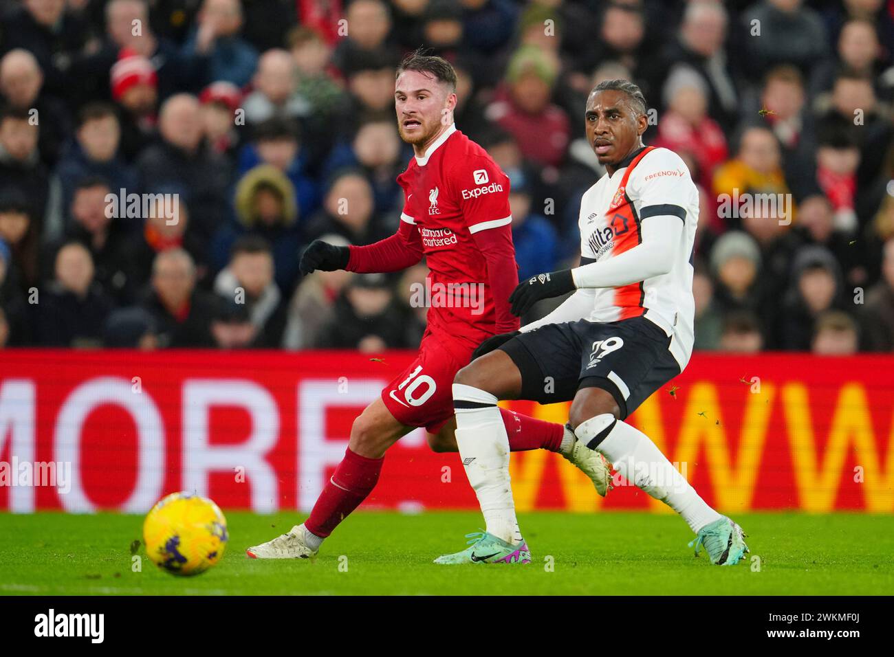 Liverpool's Alexis Mac Allister, left, challenges for the ball with ...