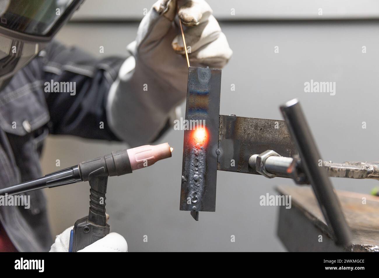 Welder man welding a metal, using a blowtorch, electric arc, or other ...