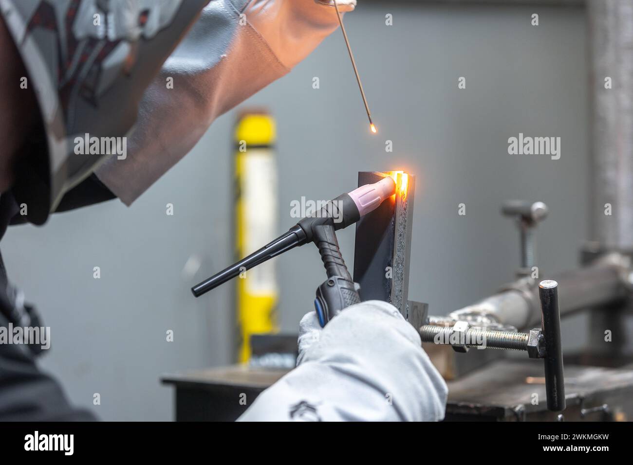 Welder man welding a metal, using a blowtorch, electric arc, or other ...