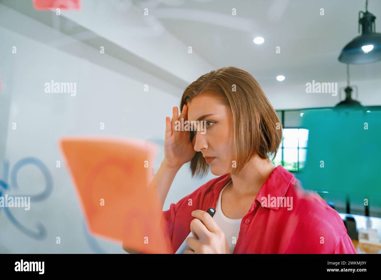 Portrait of young caucasian businesswoman thinking with confused face ...