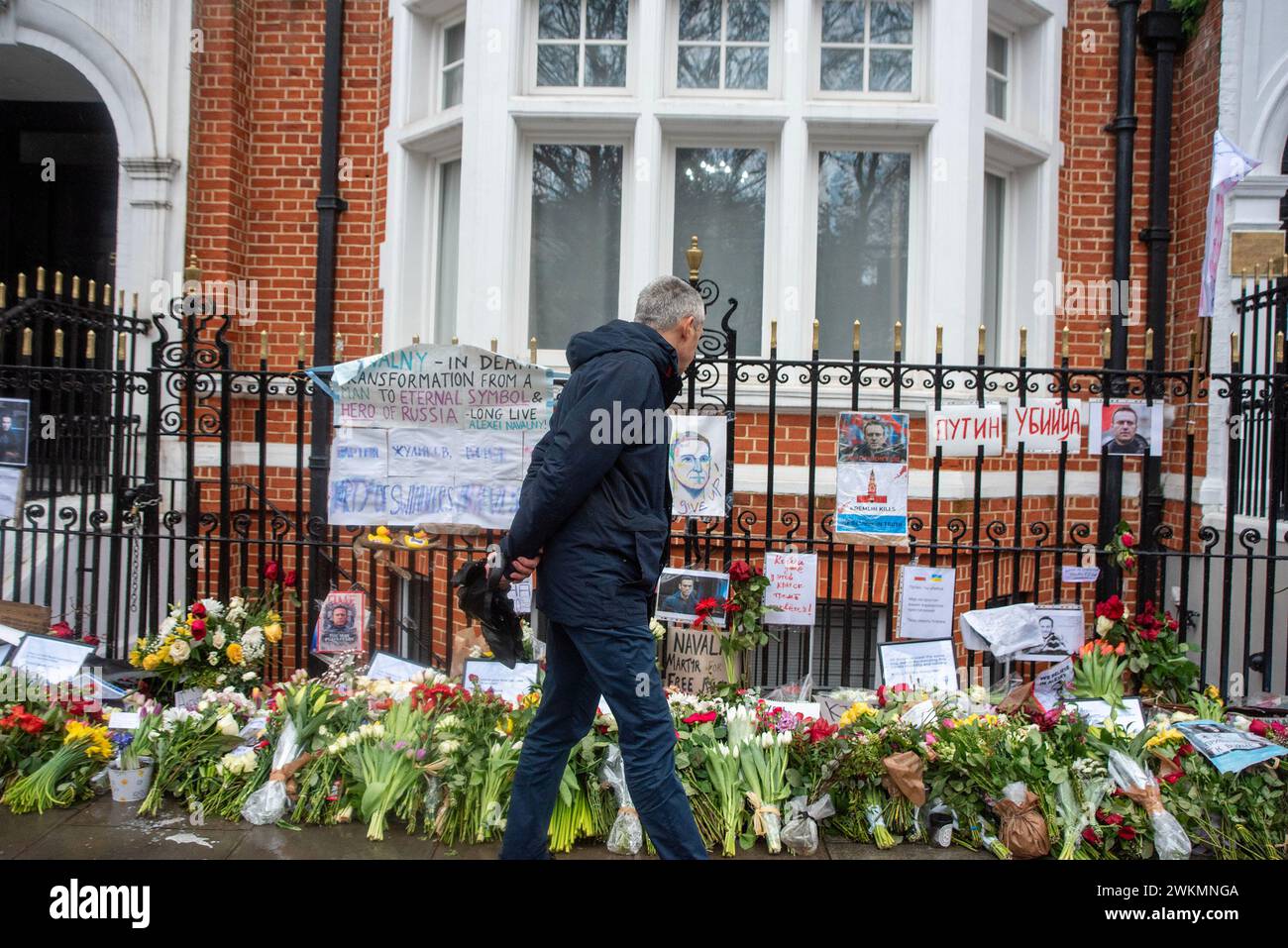 London, UK. 21st Feb, 2024. A man looks at flowers, tributes and ...