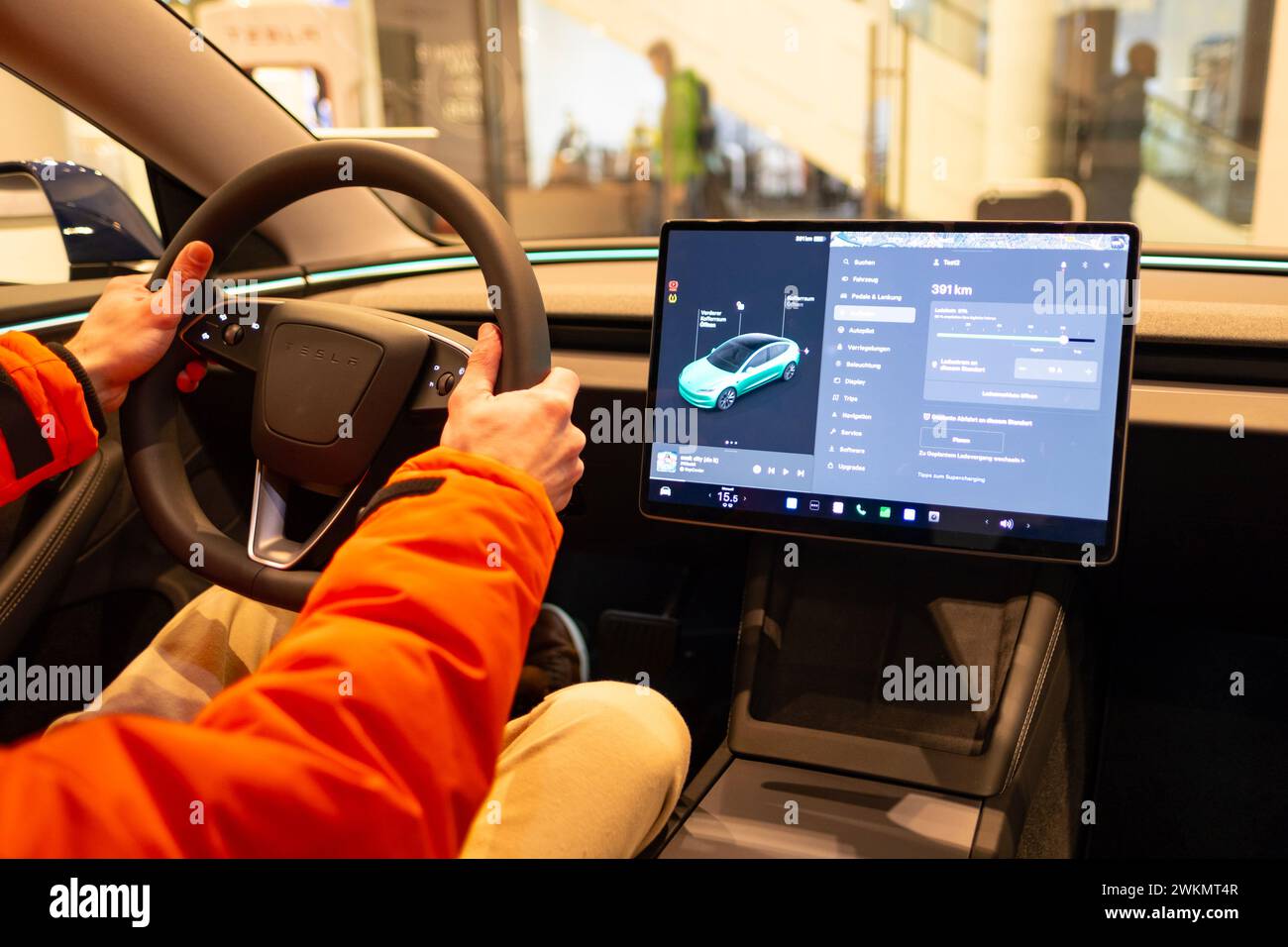 close-up male hands on steering wheel, Tesla electric car model 3 ...