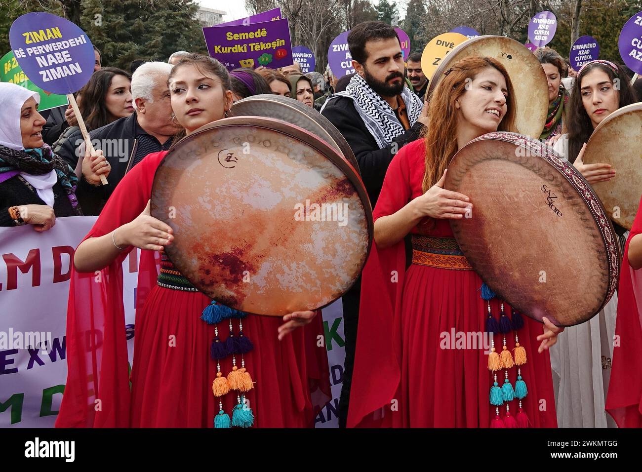 Kurdish women in national costumes are seen playing tambourines and ...