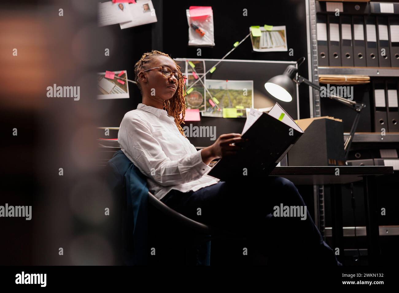 Law enforcement professional studying csi conclusion report in ...