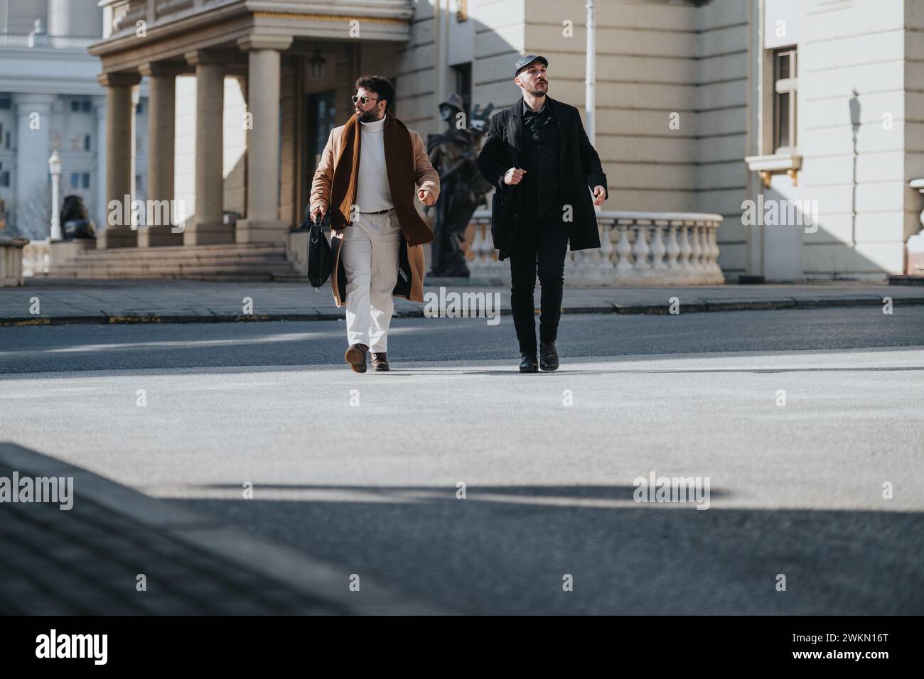 Two stylish men walking confidently on city street in autumn Stock ...