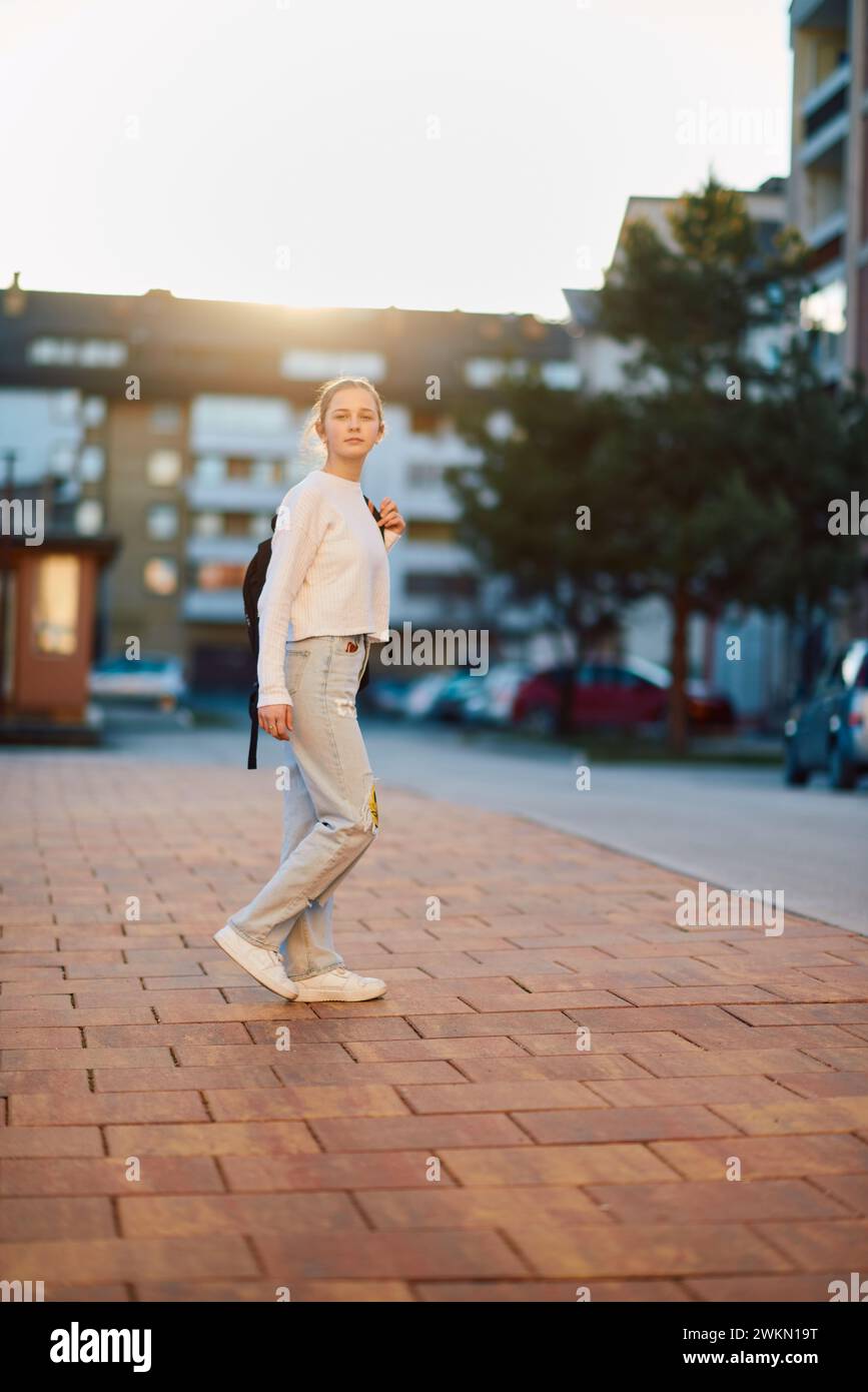 A beautiful European teenager, captured in a side-profile portrait ...