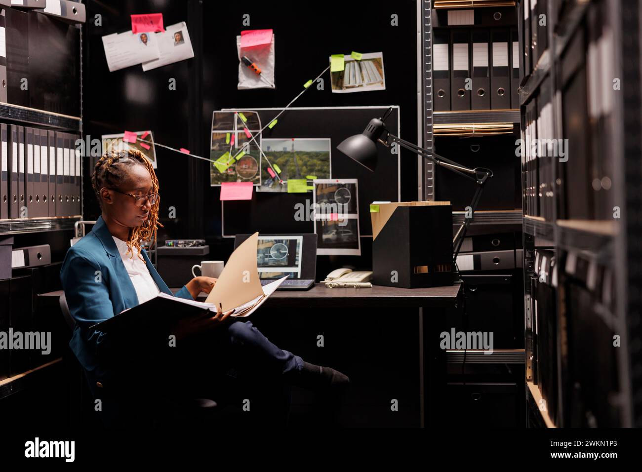 Criminal justice professional reading crime case file in police ...