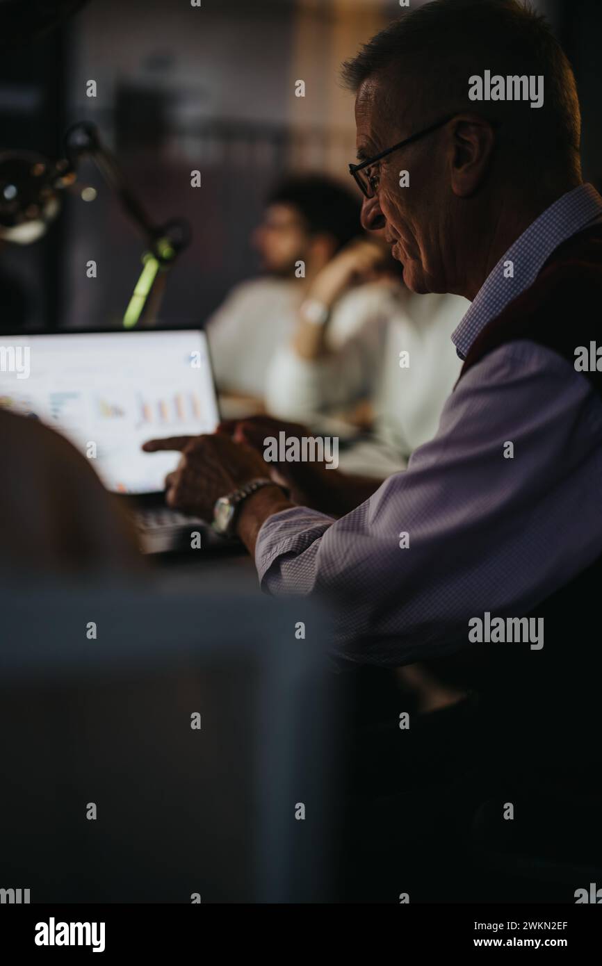 Cross generational group of business employees strategizing in the ...