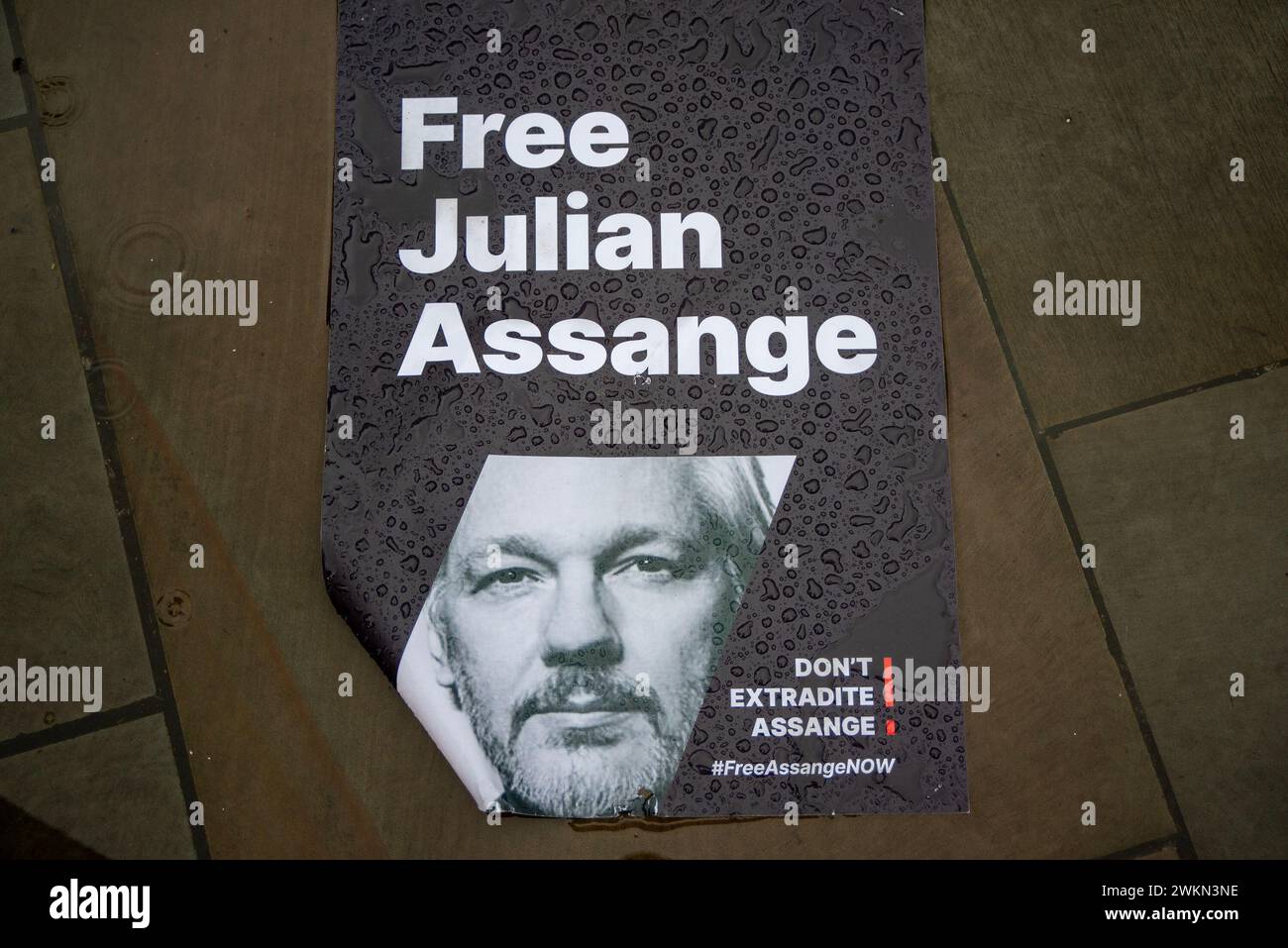 London, UK. 21st Feb, 2024. A Julian Assange poster lies on the ...
