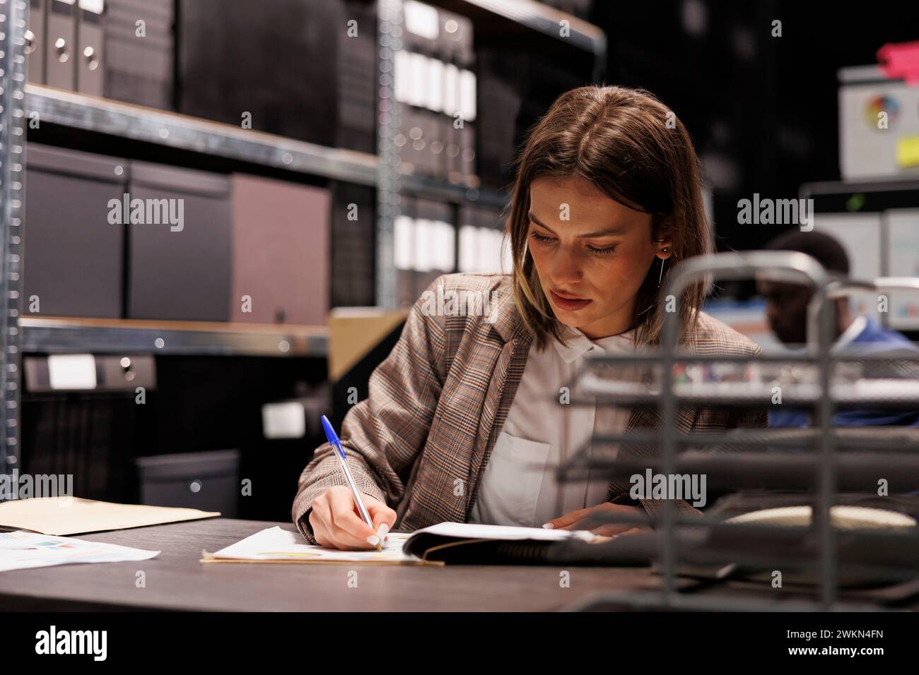 Police officer writing criminology report, working overtime at criminal ...