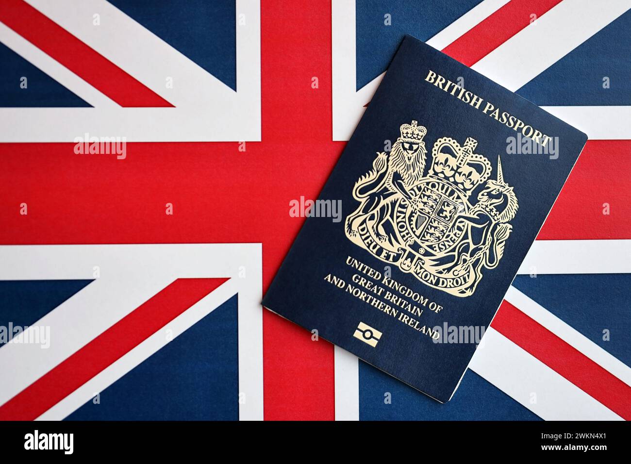 Blue British passport on national flag background close up. Tourism and ...