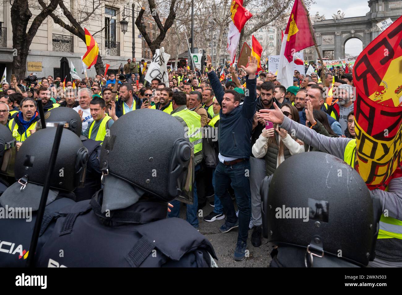 Protestors confront police officers during a farmer protest. Similarly ...