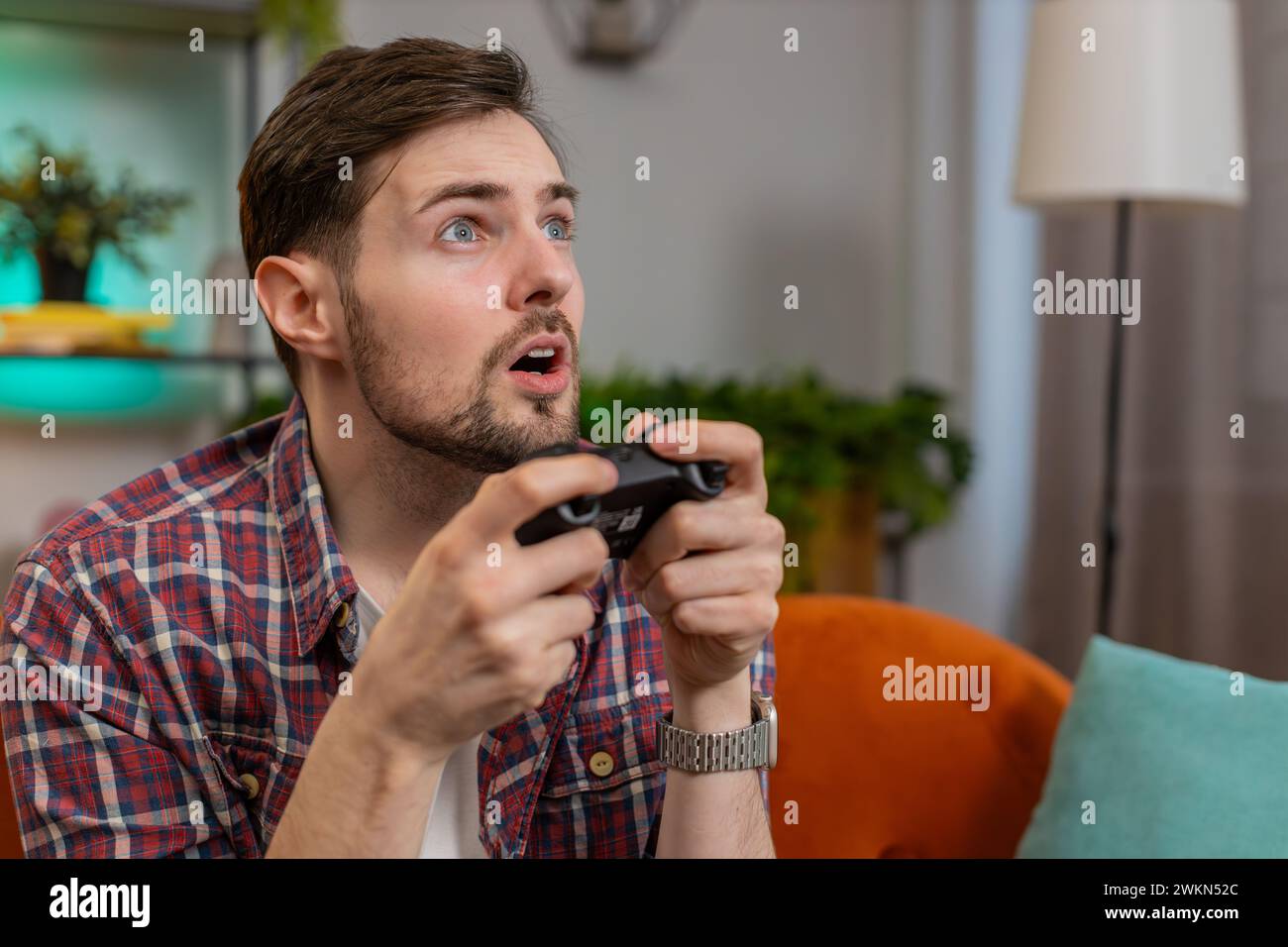 Close-up young man using joystick controller playing video console ...