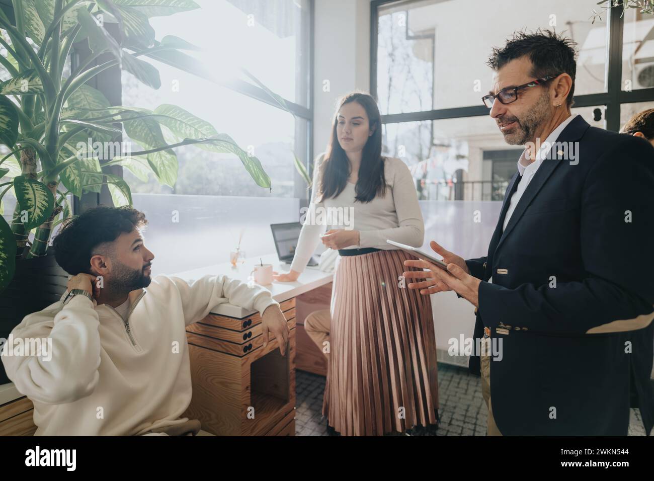 Multi generational, creative businesspeople collaborating and ...